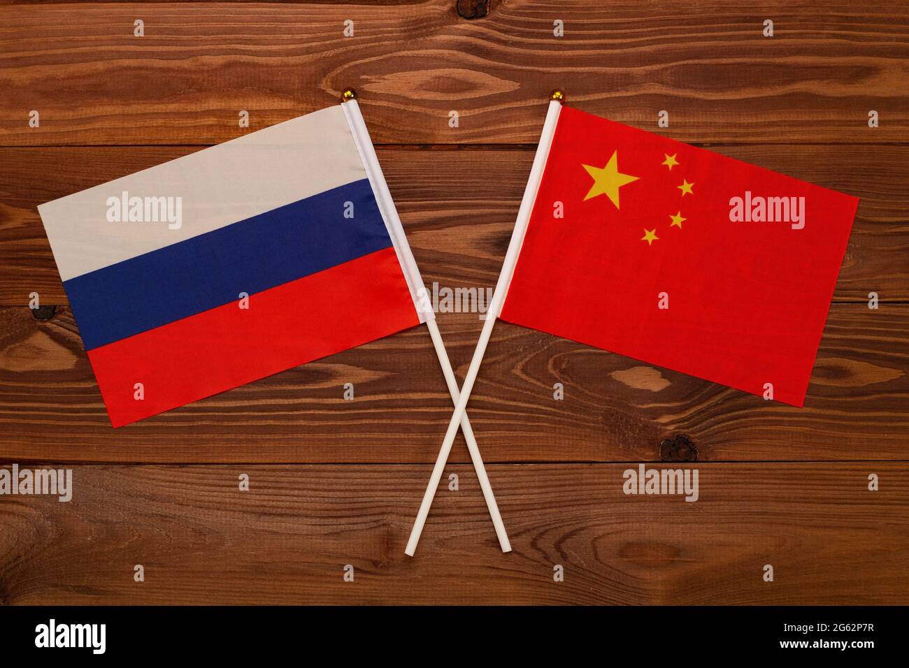 Flag of Russia and flag of China crossed with each other. The image ...