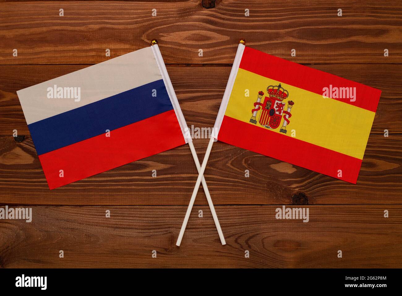 Flag of Russia and flag of Spain crossed with each other. The image ...