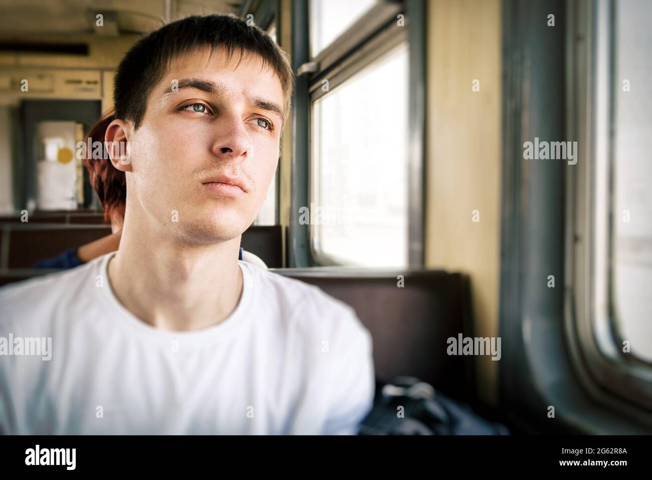 Sad Young Man sit in the Train by the Window Stock Photo - Alamy