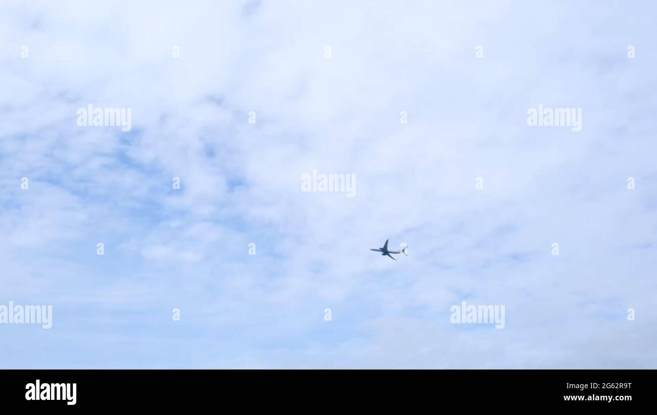 Modern large plane flies in the sky. Beautiful blue sky and white ...
