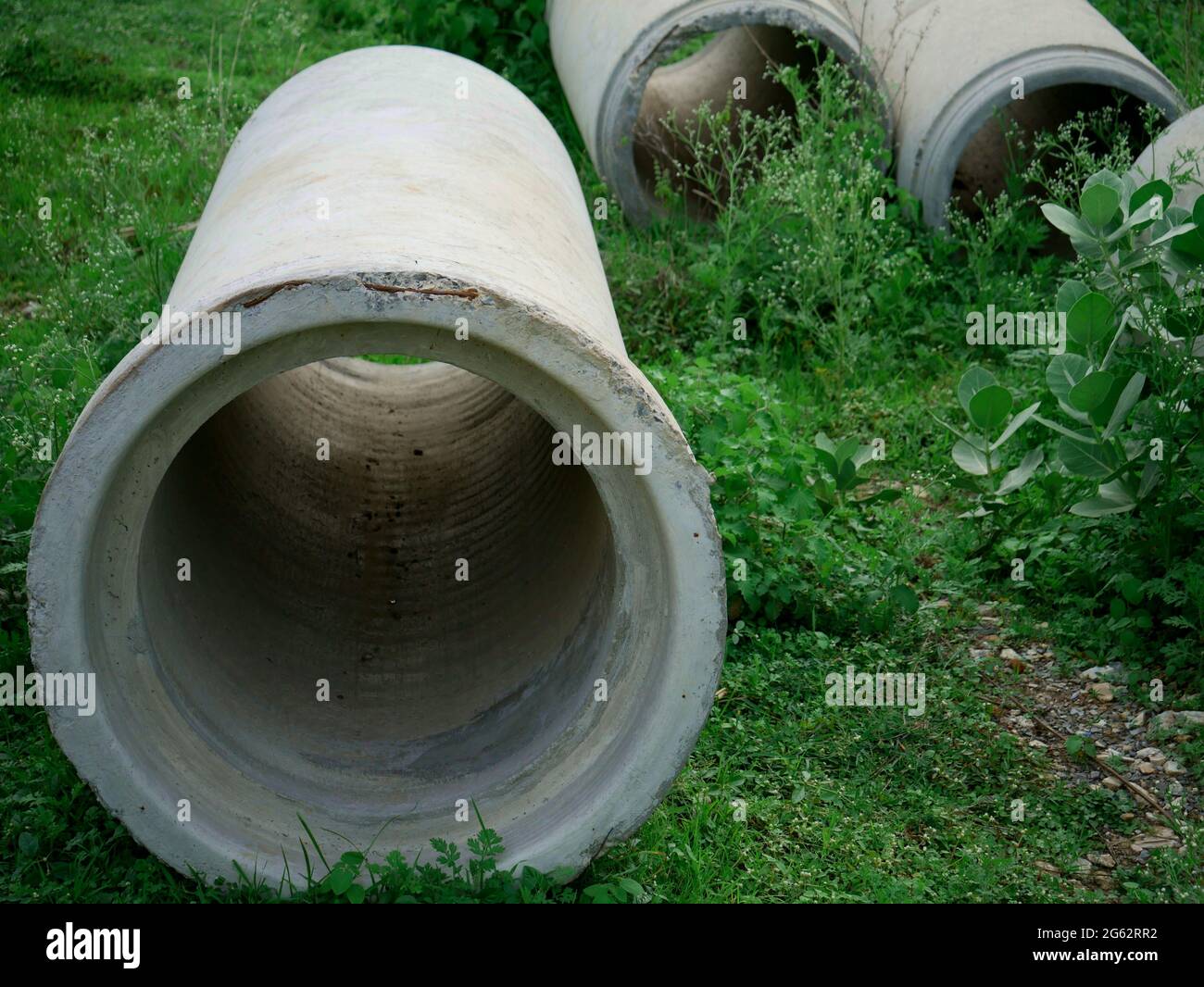 Concrete pipe presented on green grass field, industrial concept Stock ...