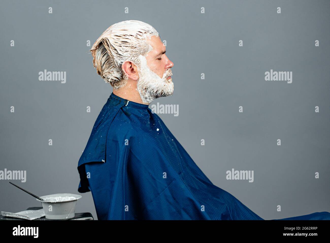 Barbershop. Portrait of bearded man color hair. Process of a man hair ...