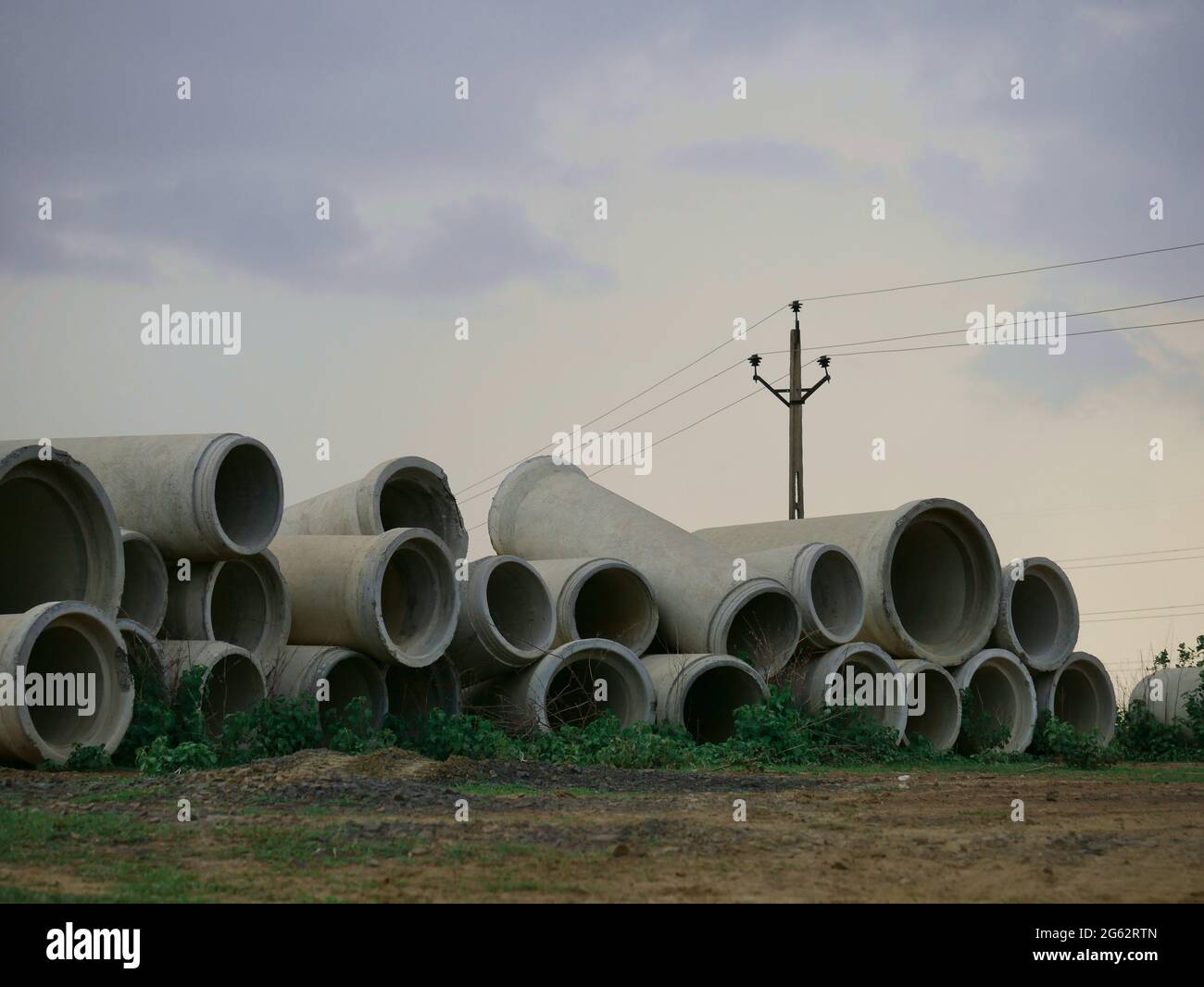 Concrete pipe stock presented soil filed on sky background industrial ...