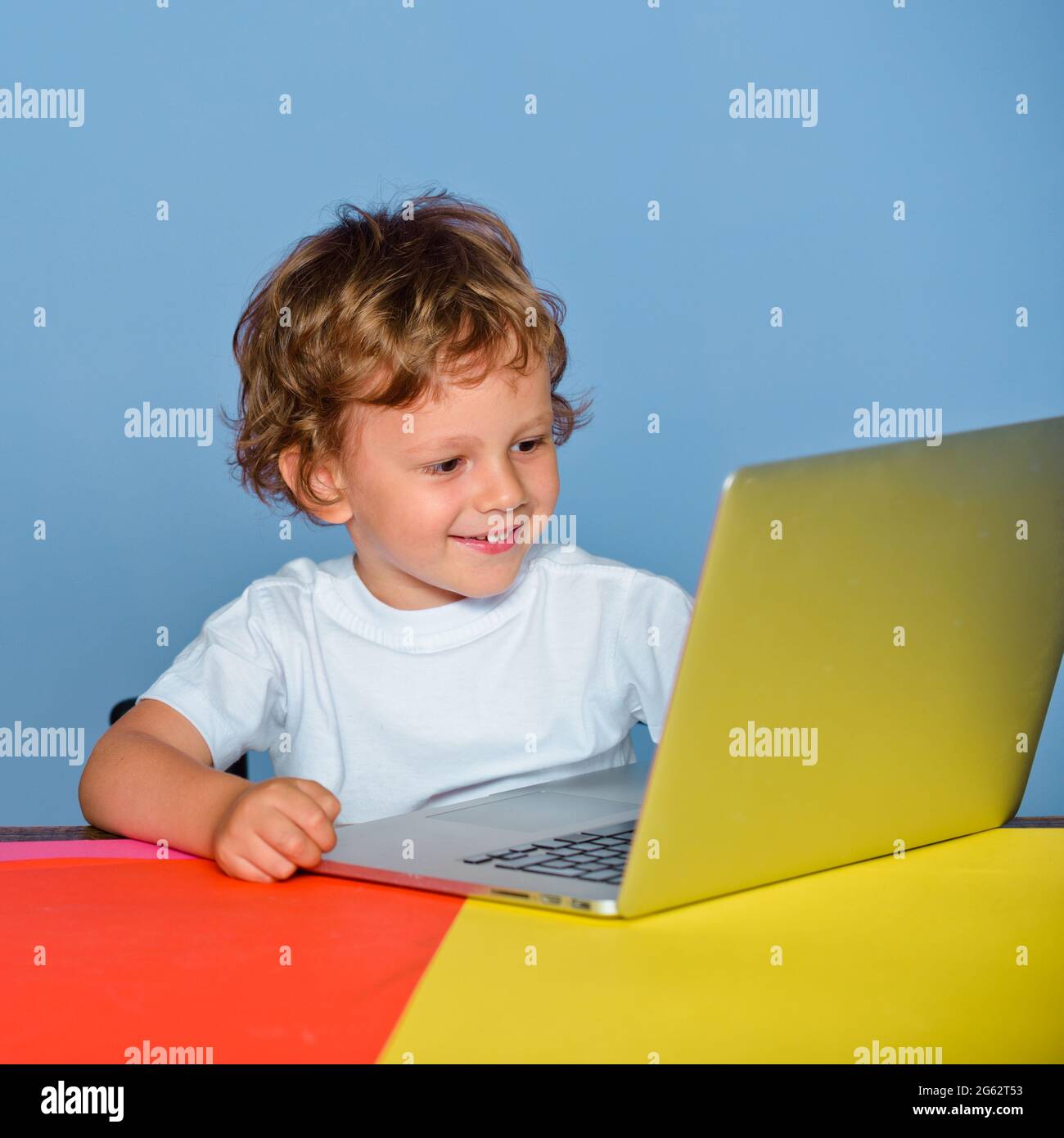 Little boy pupil with happy face expression near laptop, school concept ...
