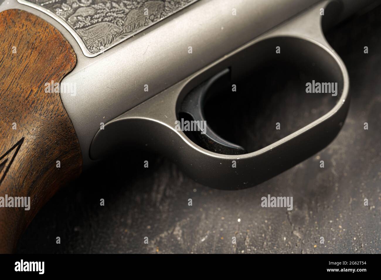 Metal trigger on hunting gun on black background Stock Photo - Alamy