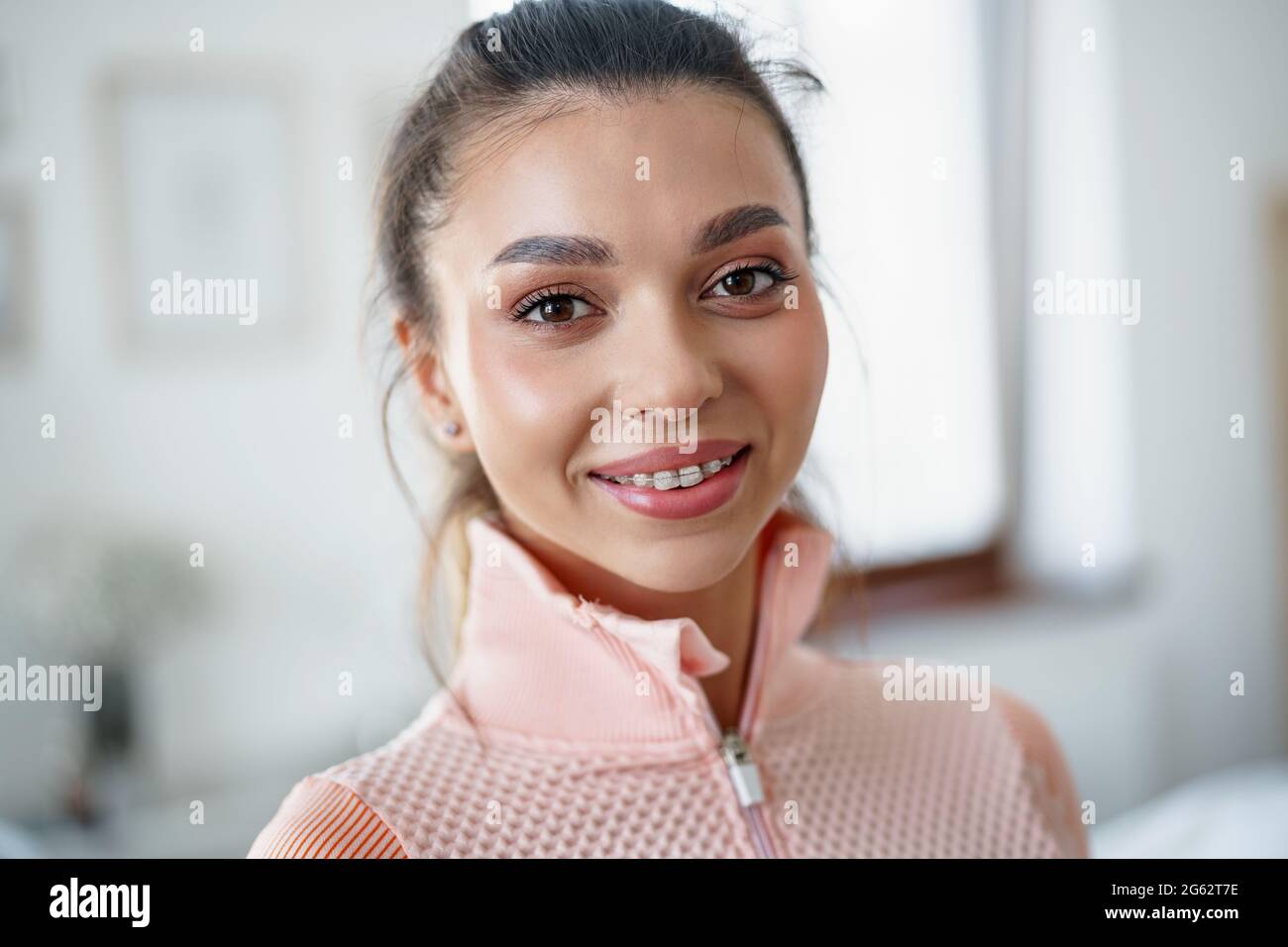 Close up portrait of a young fit girl in orange sportsuit Stock Photo ...