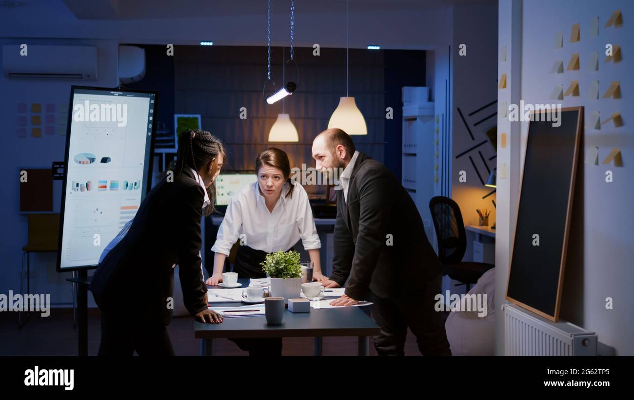 Diverse multi ethnic teamwork standing around table brainstorming ...