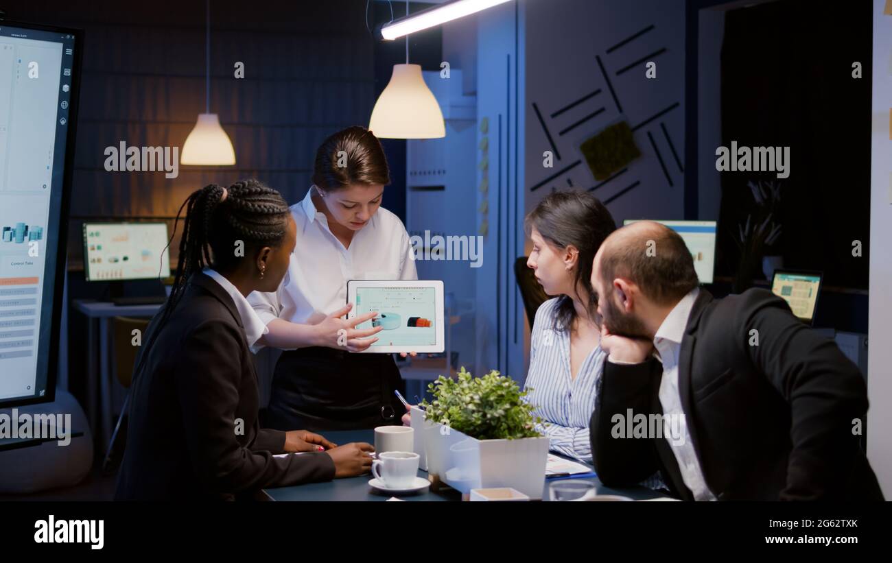 Workaholic focused businesswoman holding tablet explaining company ...