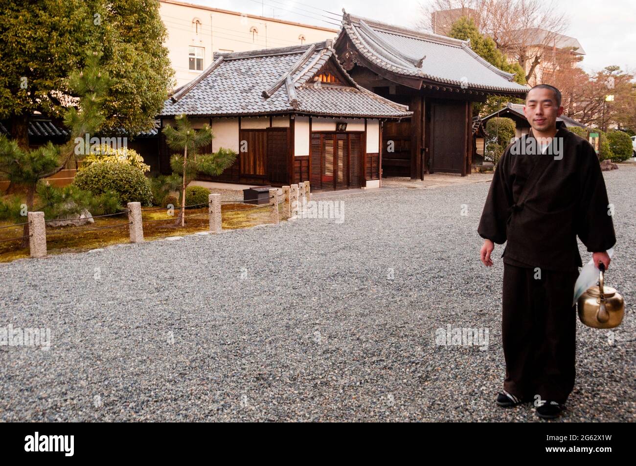 A Japanese monk carrying a pot of tea on a Buddhist temple complex in ...