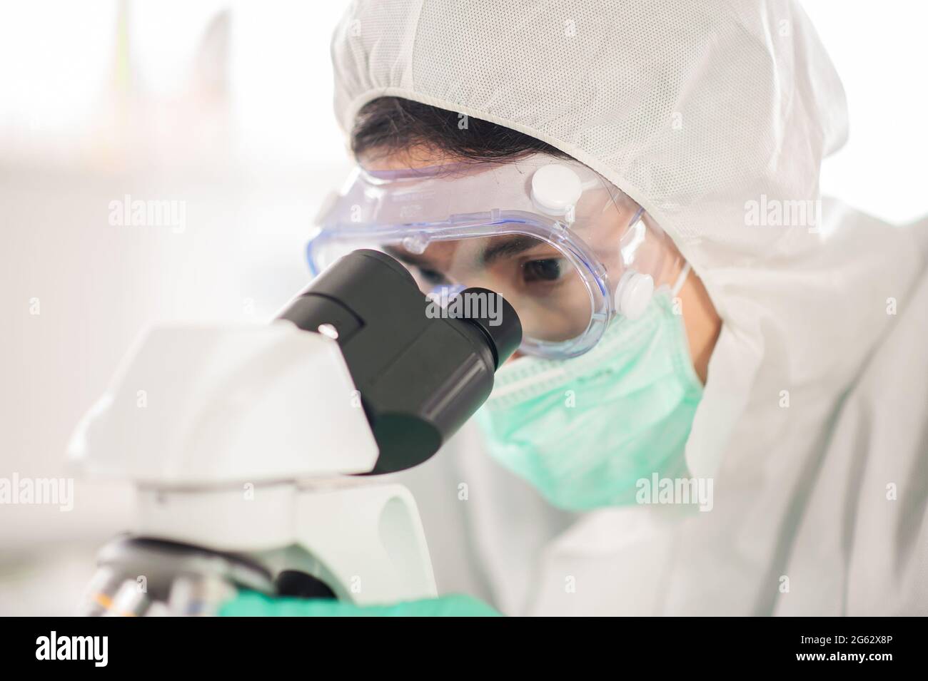 Close up Doctor using microscope in hospital lab check for germs Stock ...