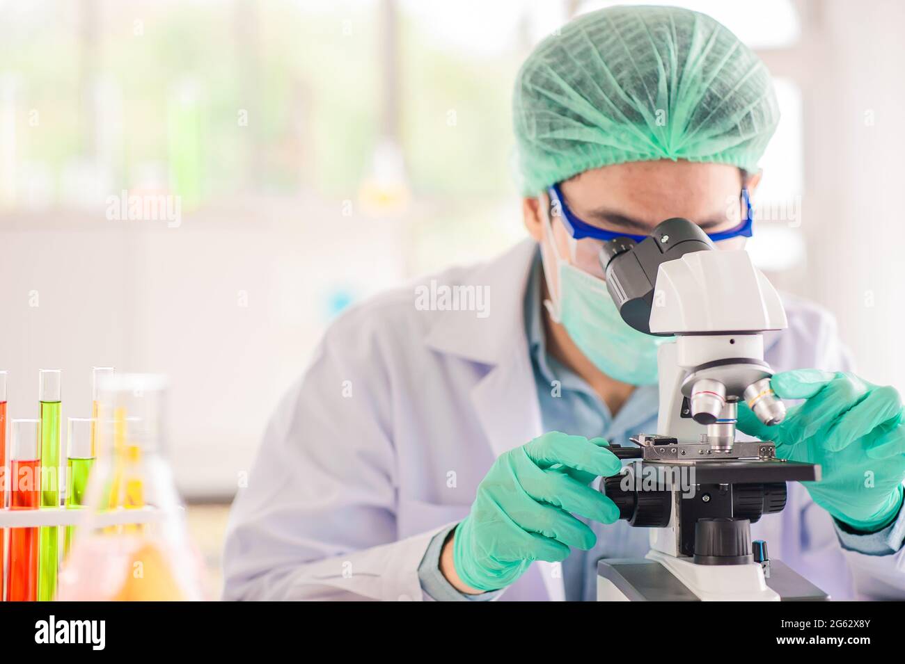 Close up Doctor using microscope in hospital lab check for germs Stock ...