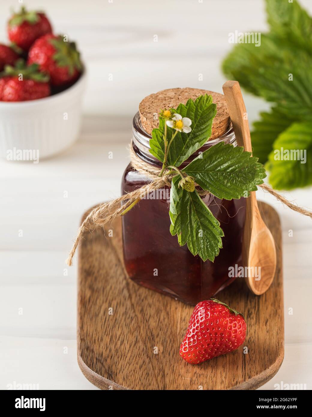 Strawberry jam in a jar on a wooden board. Fermented berries Stock ...