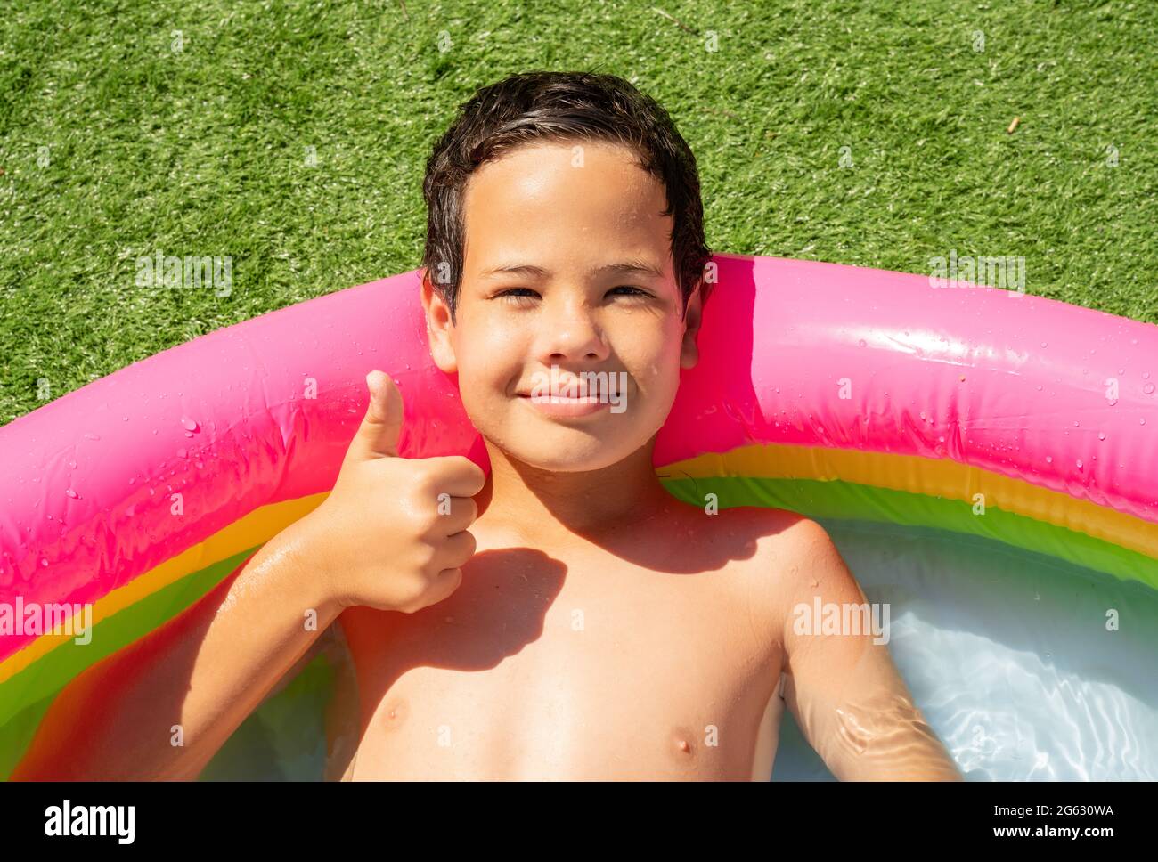 Happy kid lying thumb up hi-res stock photography and images - Alamy