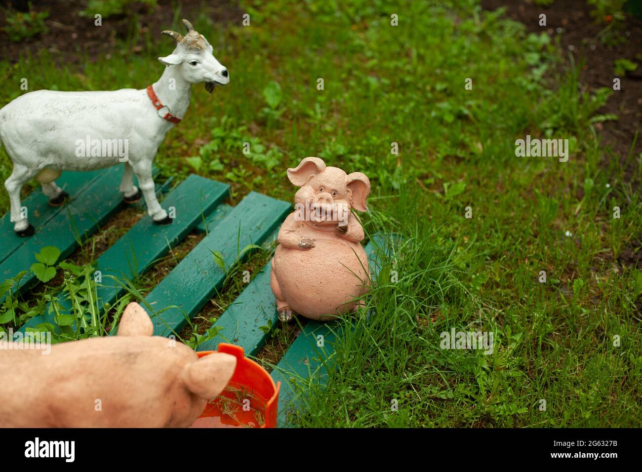 Figures of animals on the lawn. Figurines for flower bed decoration ...