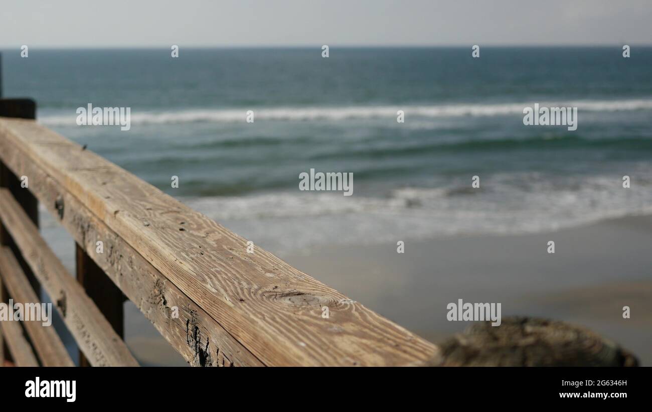 Railings of old wooden pier, waterfront boardwalk, Oceanside beach ...