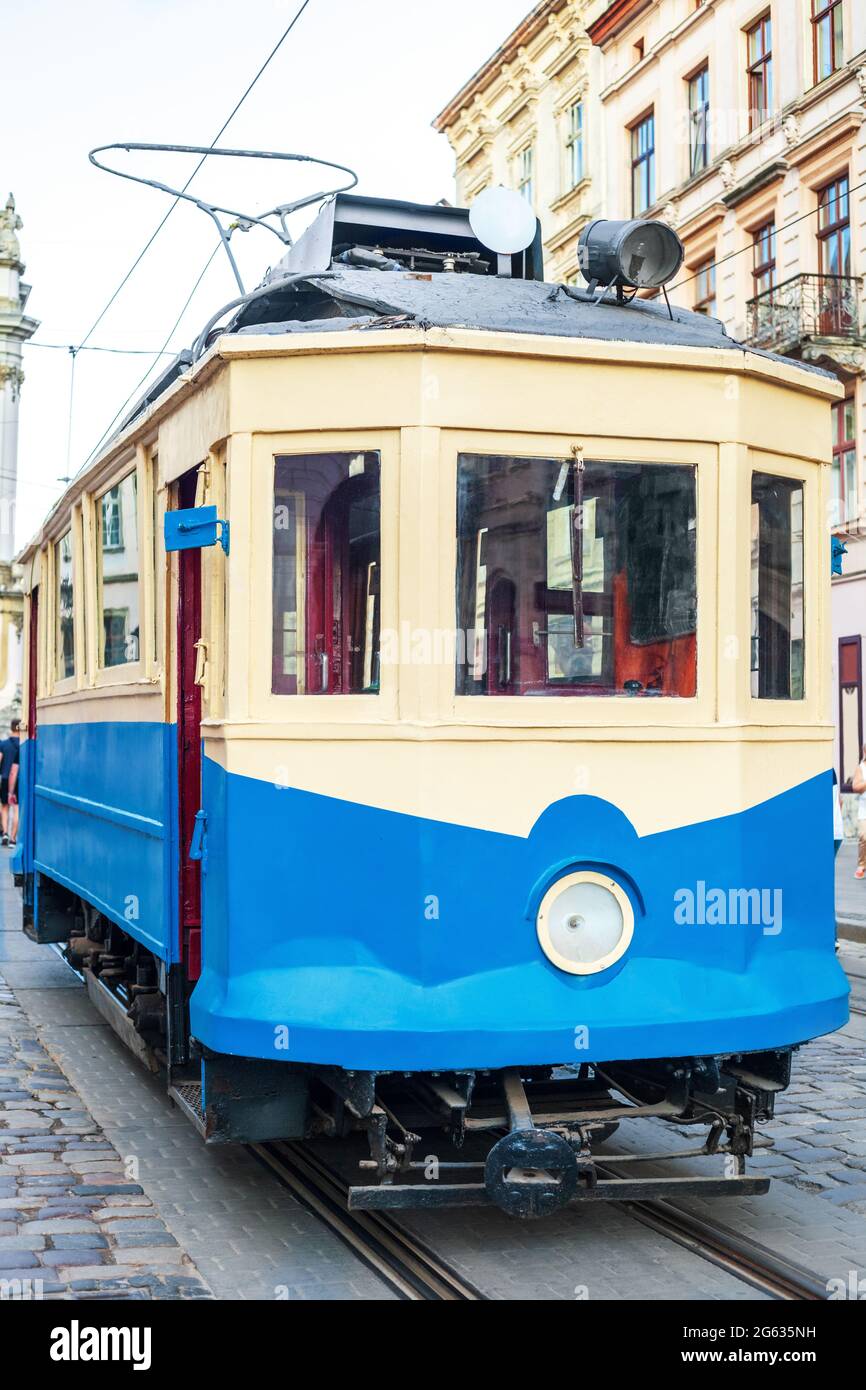 Vintage old tram at old town market square. Blue electric train driving ...