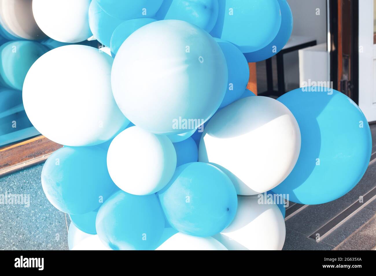 White and blue balloons near shop door. New store decorated ballons ...