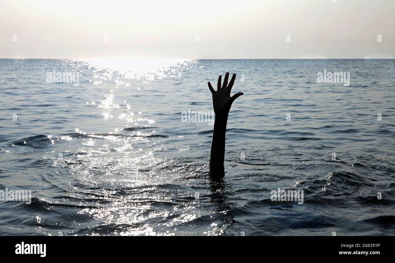 Hand ask help on the water of the sea Stock Photo - Alamy