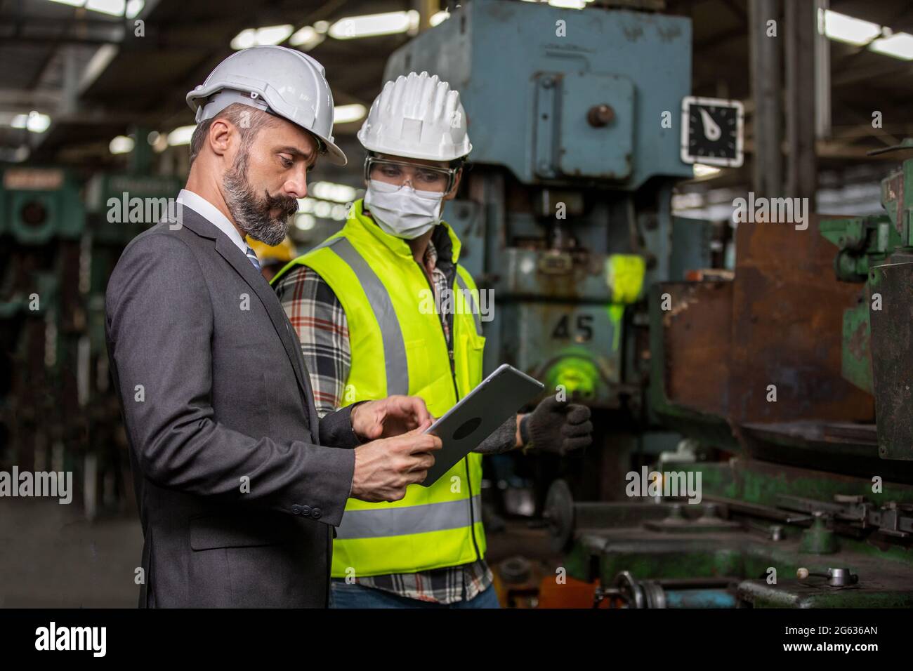 Engineer manager and Factory Workers Team checking machine in ...