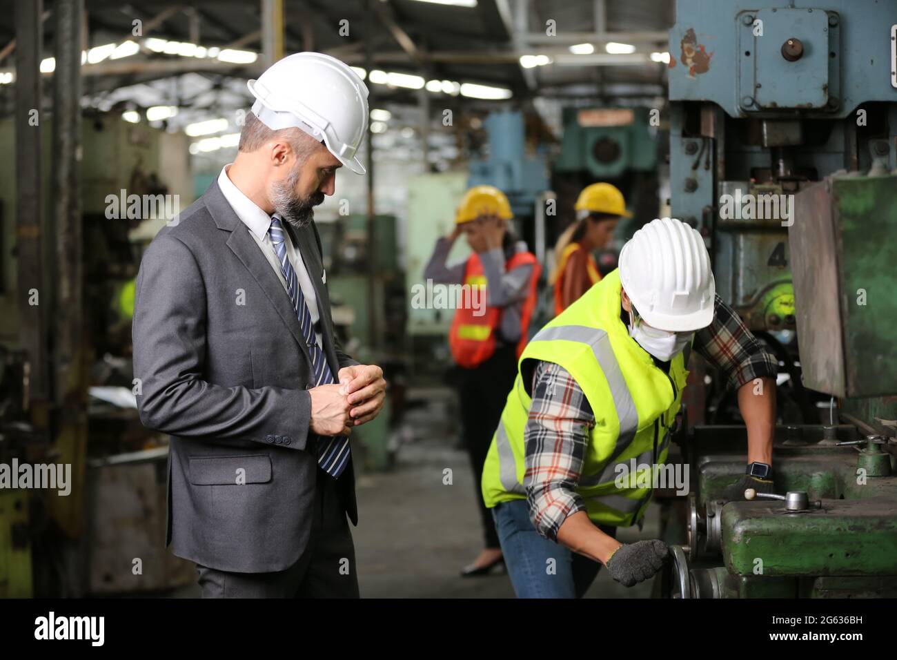 Caucasian construction workers checking equipment hi-res stock ...