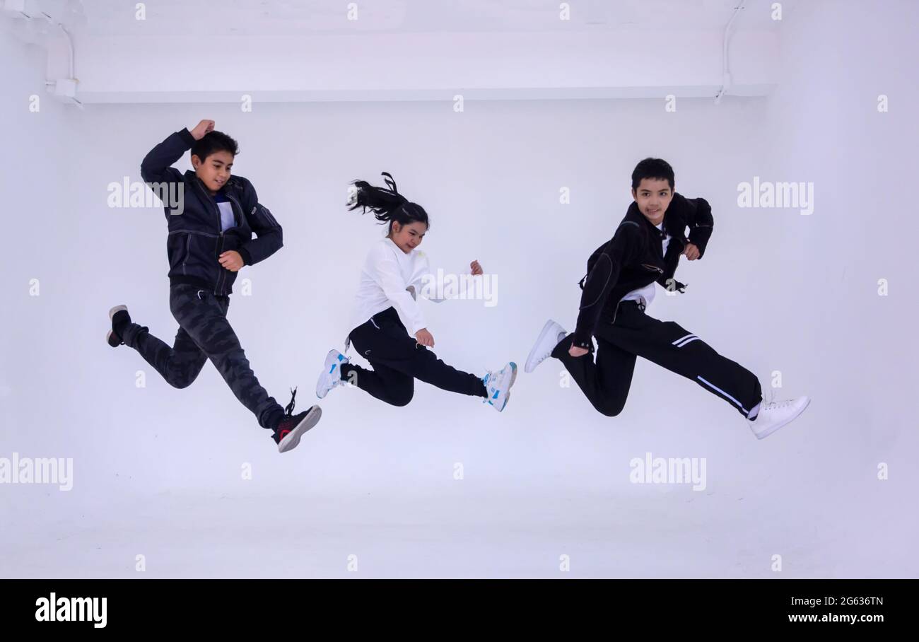 three kid jumping and trainer dancing isolated on white background ...