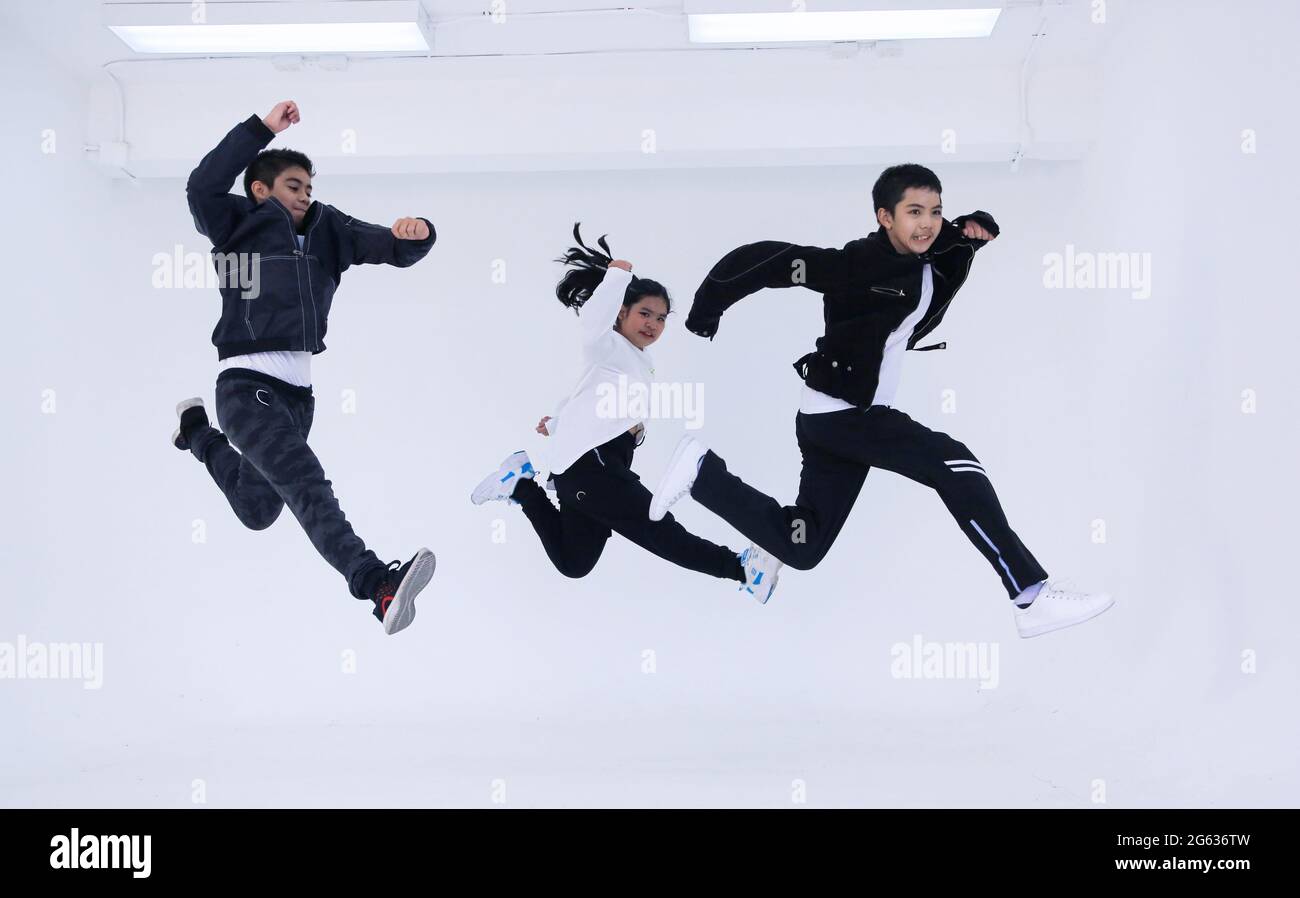 three kid jumping and trainer dancing isolated on white background ...