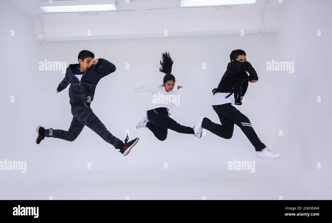 three kid jumping and trainer dancing isolated on white background ...