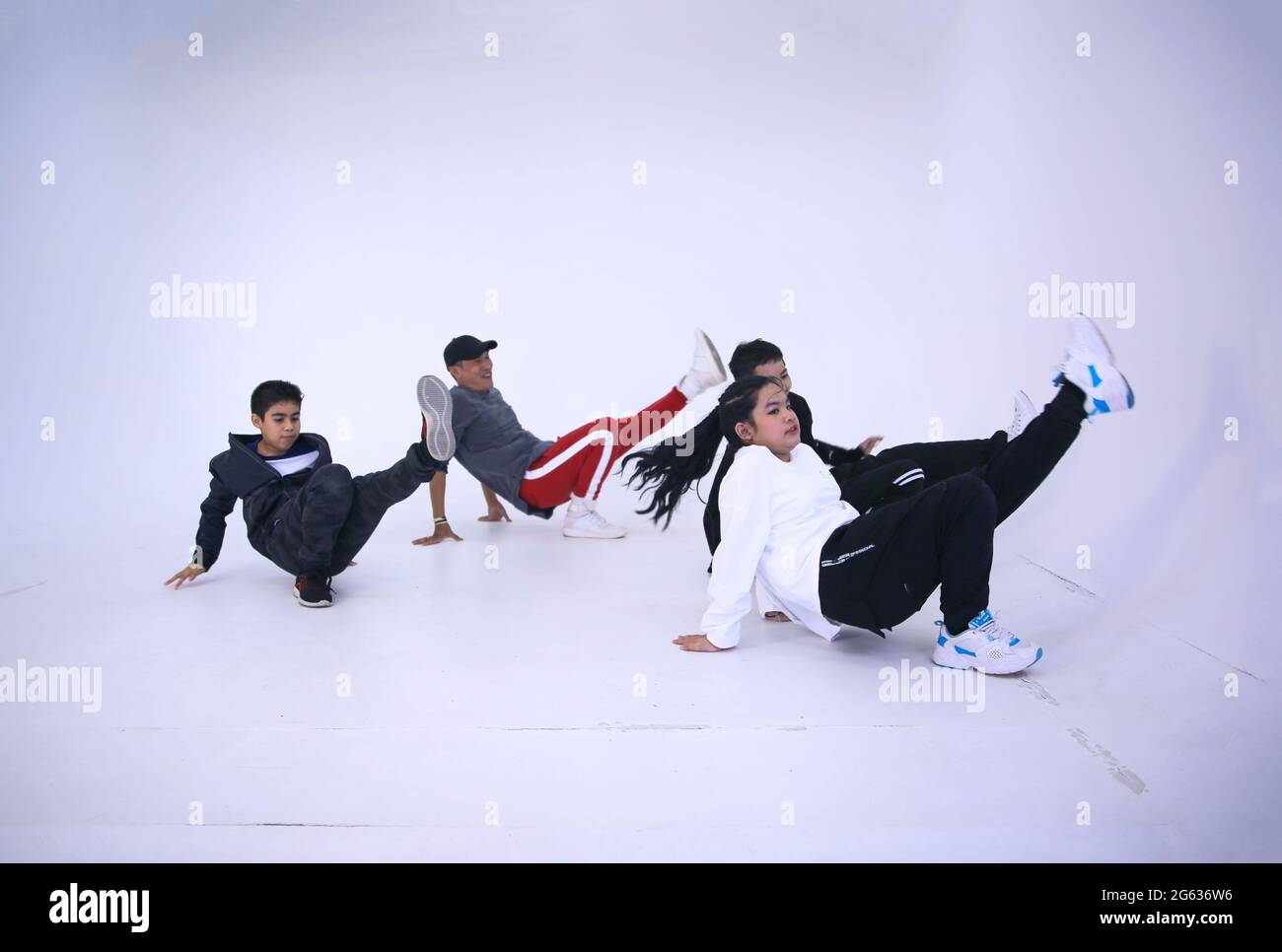 three kid jumping and trainer dancing isolated on white background ...