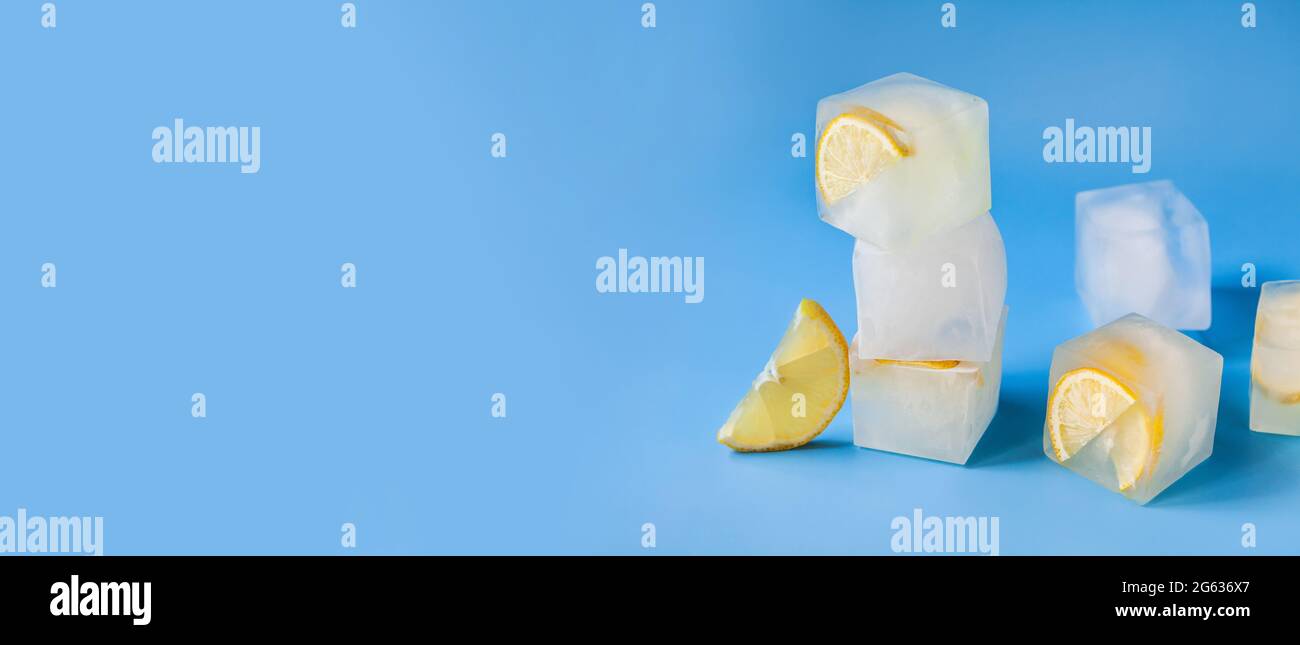 Modern composition of the frozen slices of lemon and ice cubes on a blue background Stock Photo ...