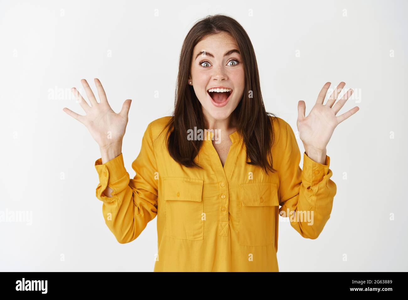 Surprised woman gasping and shaking hands amazed, receive presents and ...