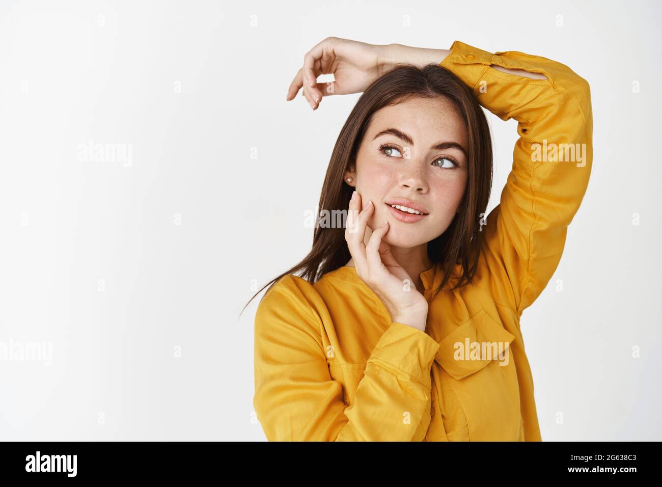 Beautiful female model with straight hair and thick eyebrows posing on ...