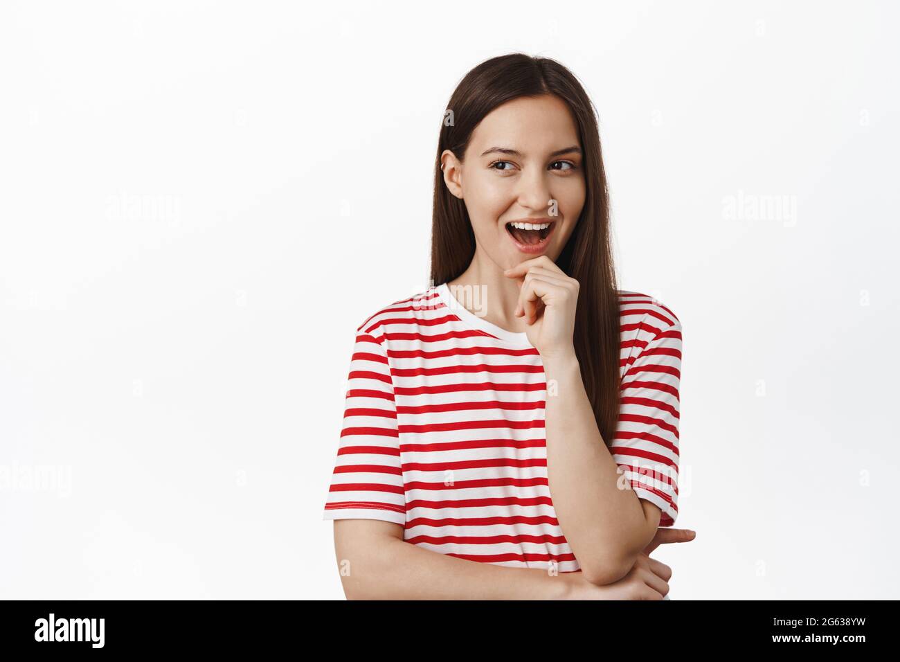 Image of intrigued young woman has an idea, look cunning and smiling ...