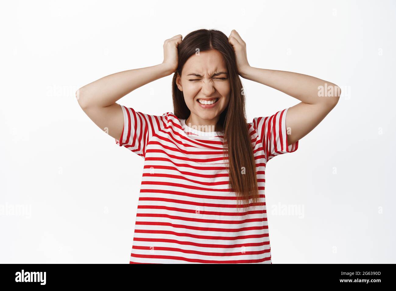 Image of frustrated 20s girl hold hands on head, squinting and ...