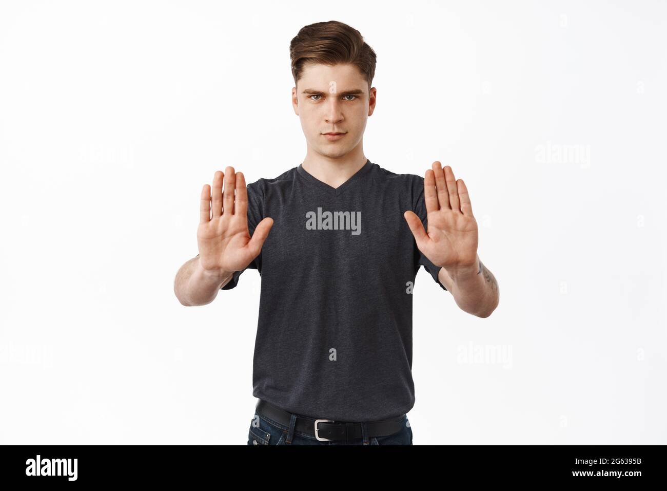 Portrait of angry young man push away, showing stop block gesture ...