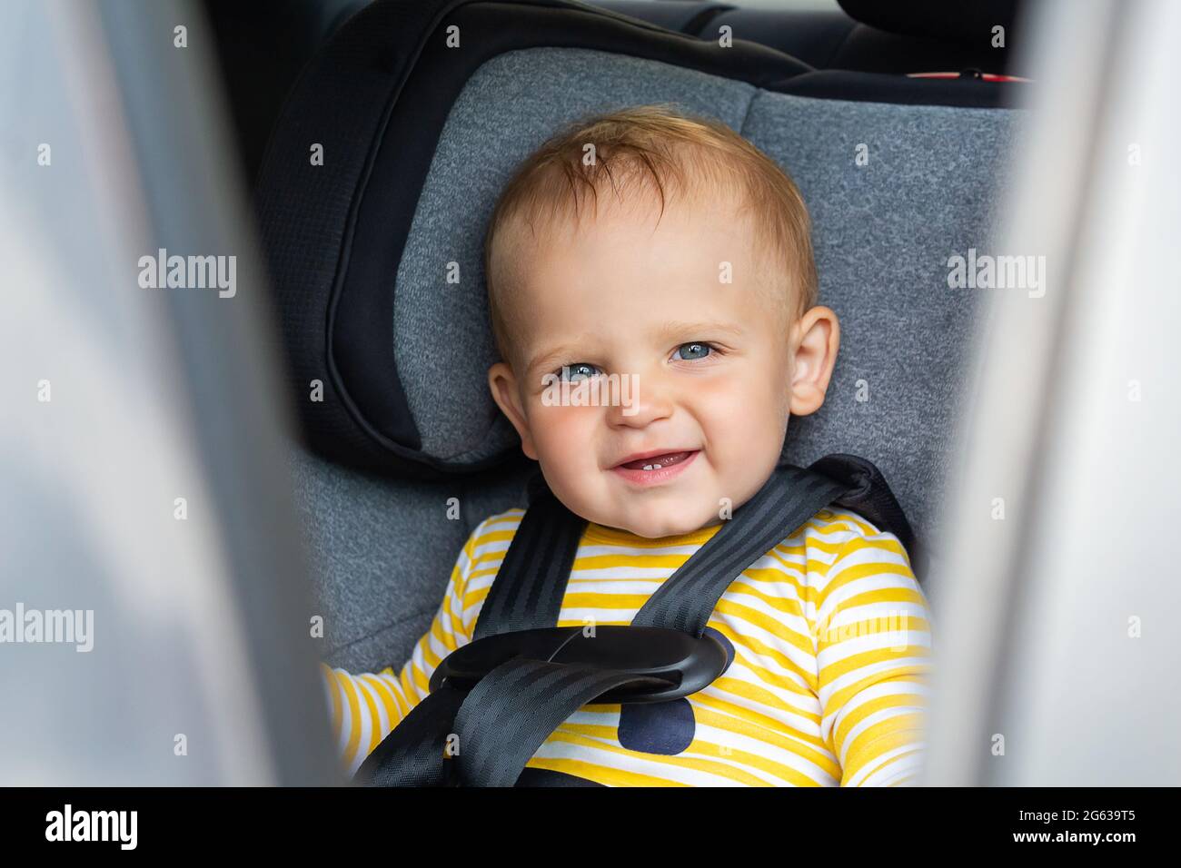 Happy baby boy sitting in car seat Stock Photo - Alamy