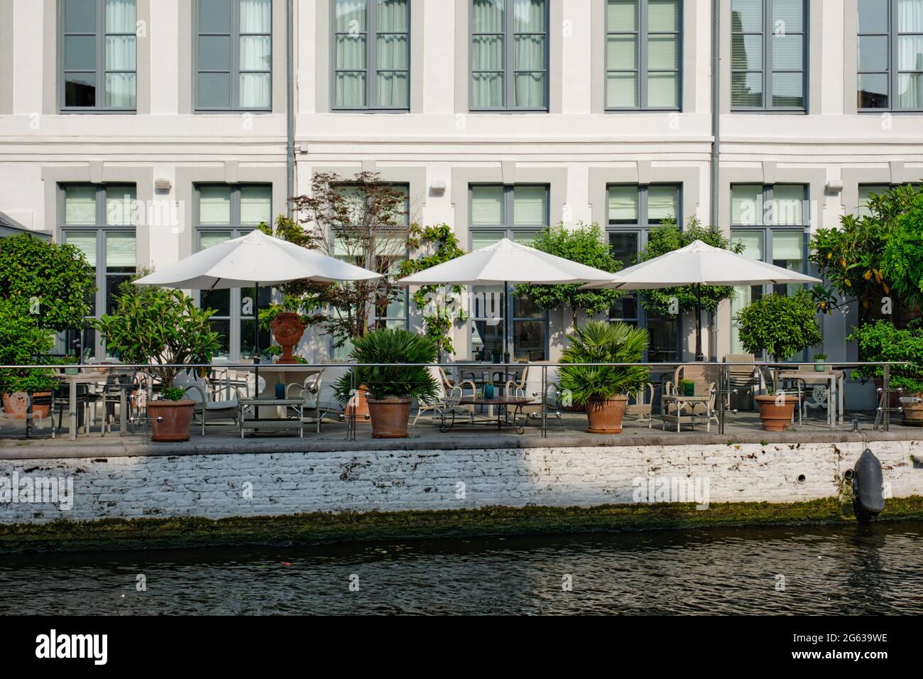 Cafe tables along canal in Bruges, Belgium Stock Photo - Alamy