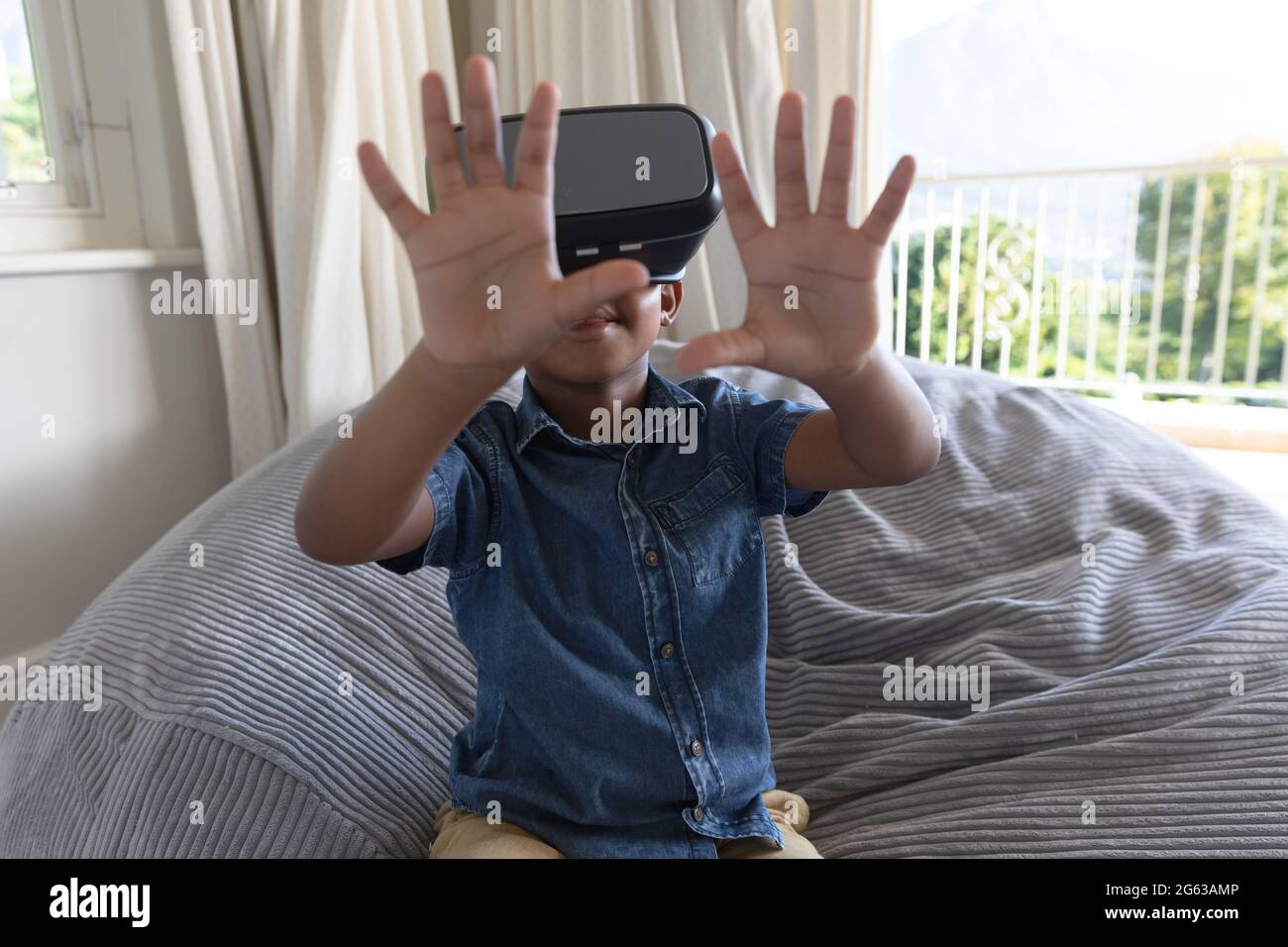 Happy african american boy using vr headset and smiling at home Stock ...