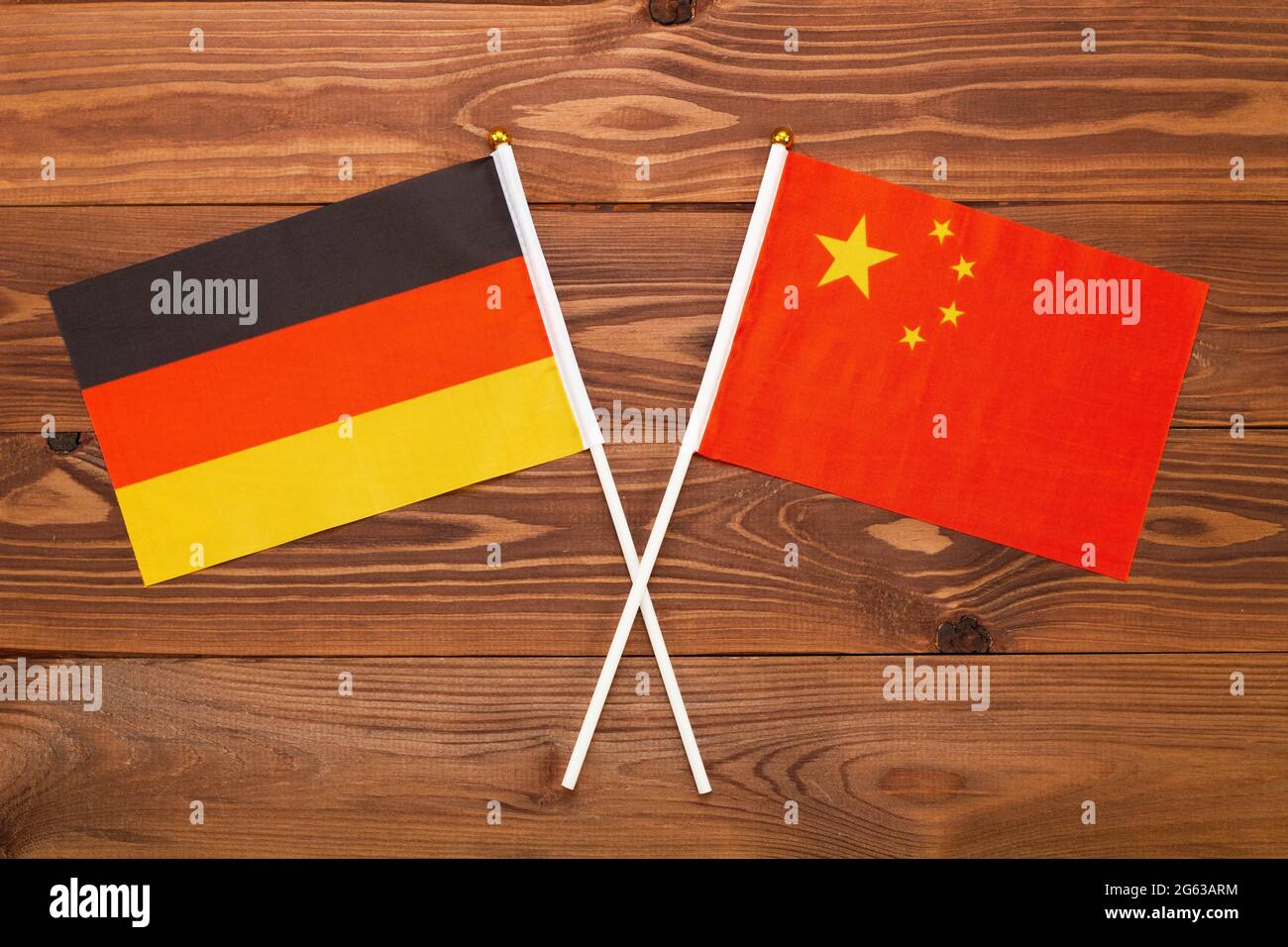 Flag of Germany and flag of China crossed with each other. The image ...