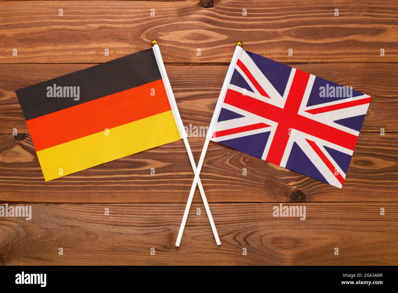 Flag of Germany and flag of Great Britain crossed with each other. The ...