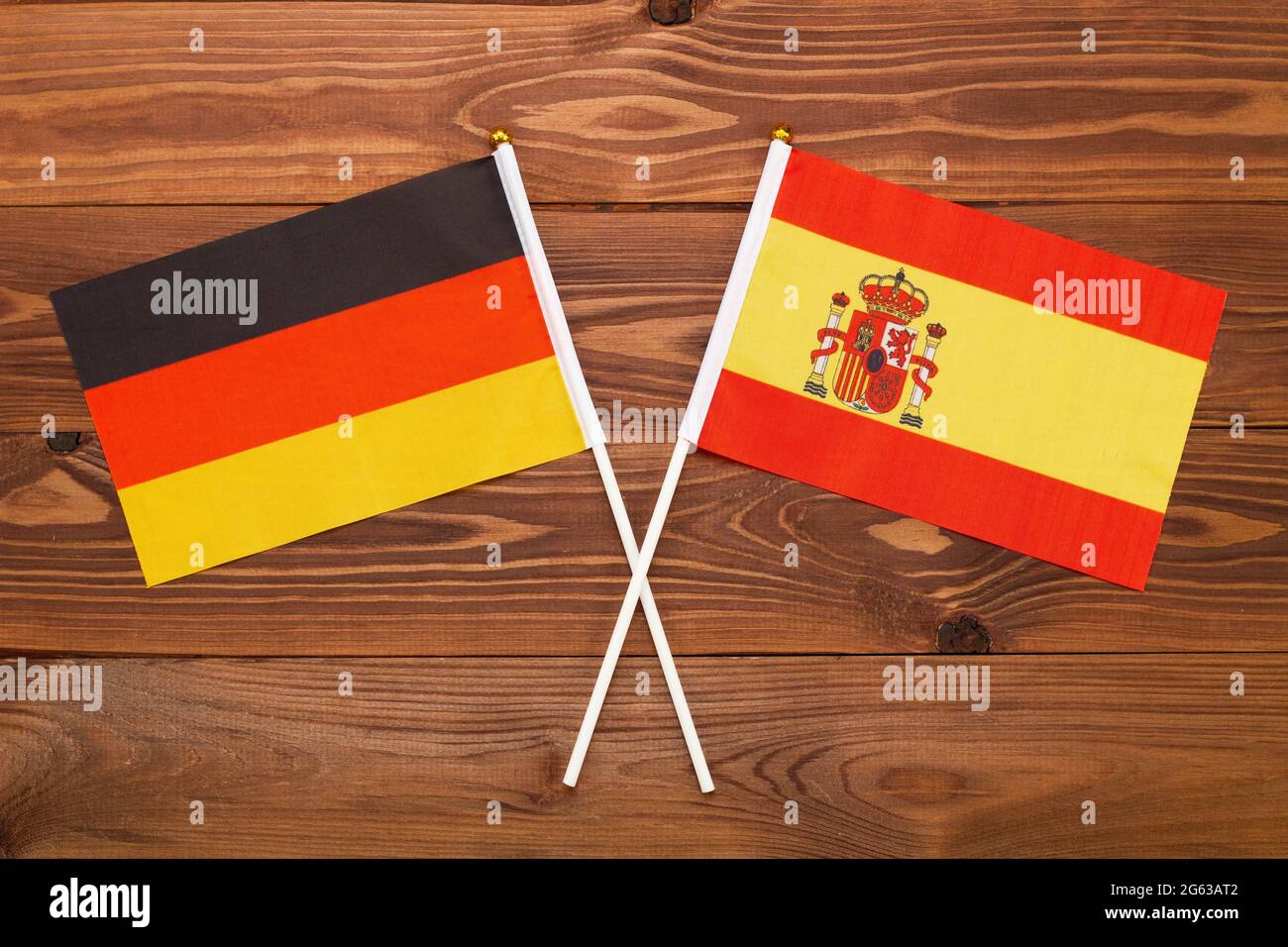 Flag of Germany and flag of Spain crossed with each other. The image ...