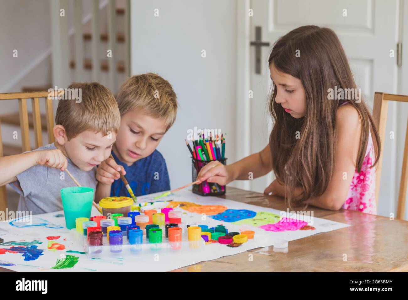 Siblings together create one picture at home Stock Photo - Alamy