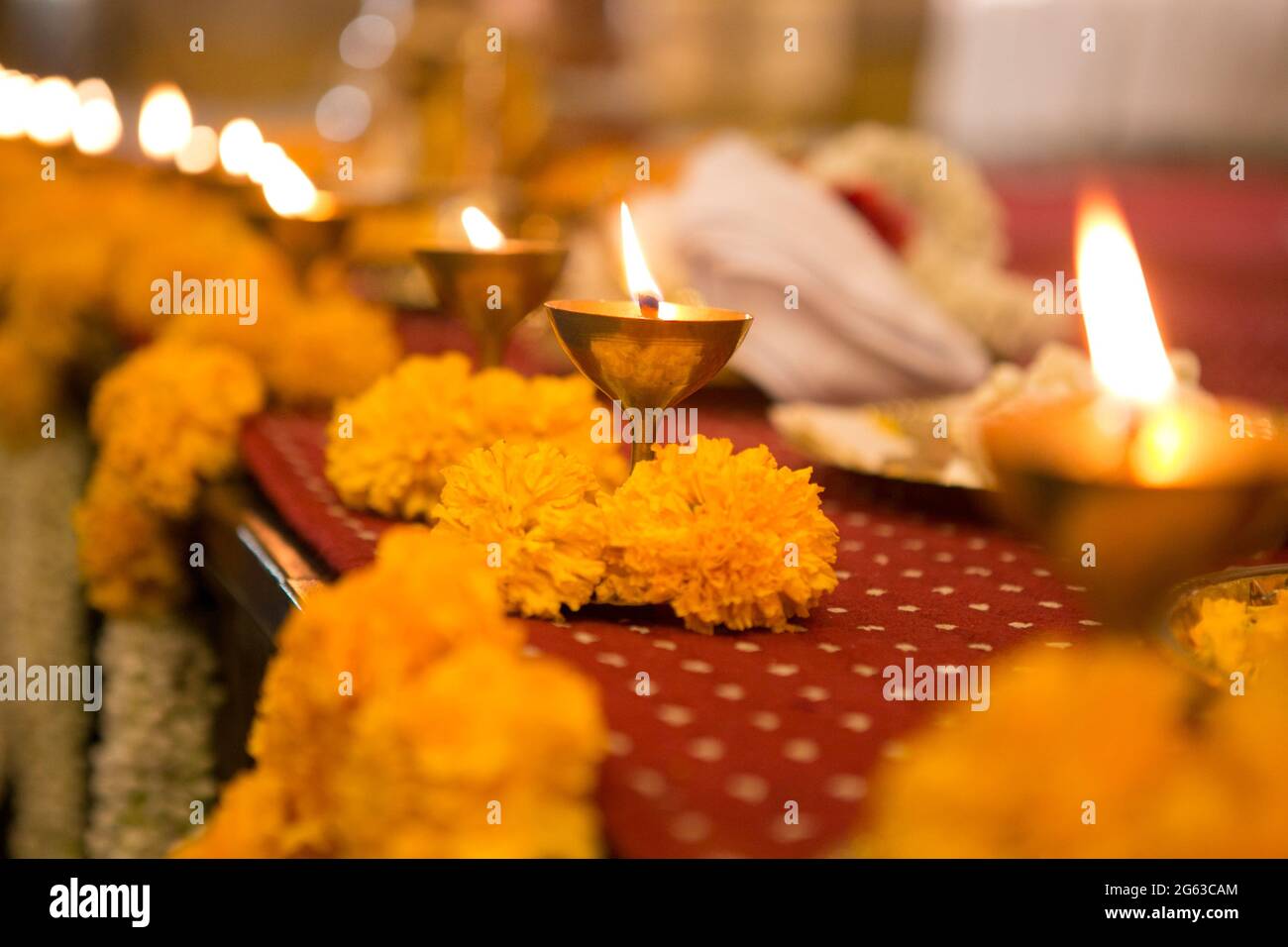 Candles decorated with flowers during a traditional Hindu ritual Stock ...