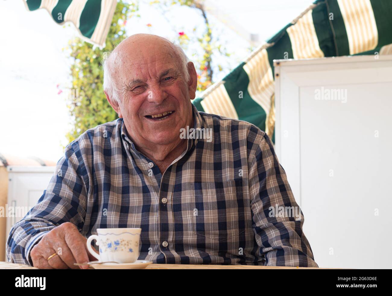 Old man laughing with a cup of coffee Stock Photo - Alamy