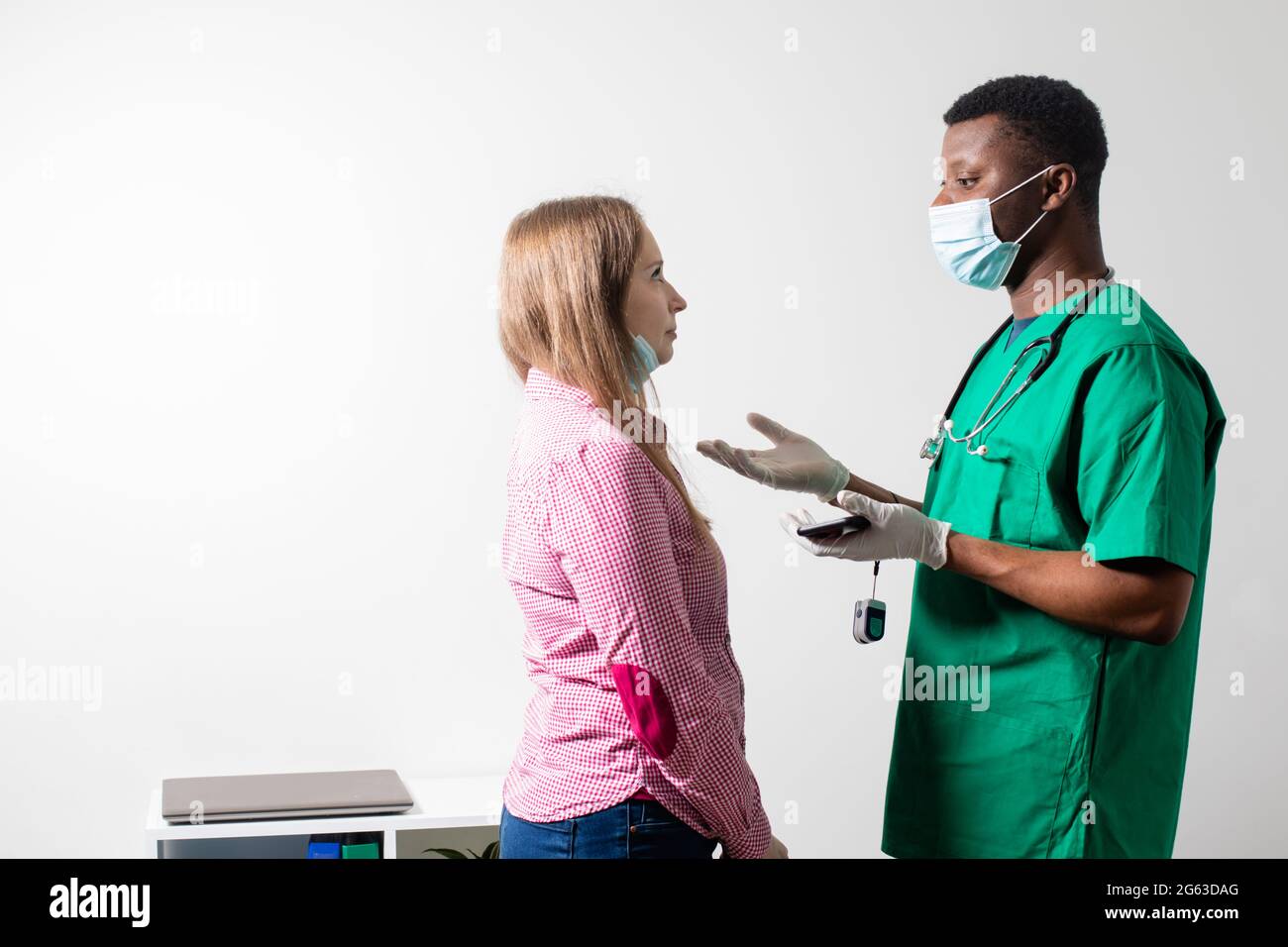 Keeping social distance during family doctor visit Stock Photo - Alamy