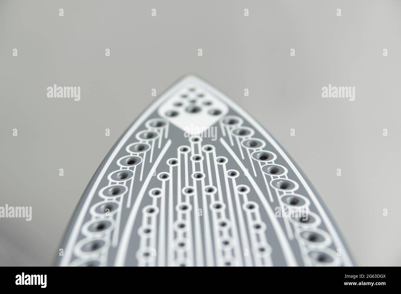 Bottom surface of the Iron with a holes Stock Photo - Alamy
