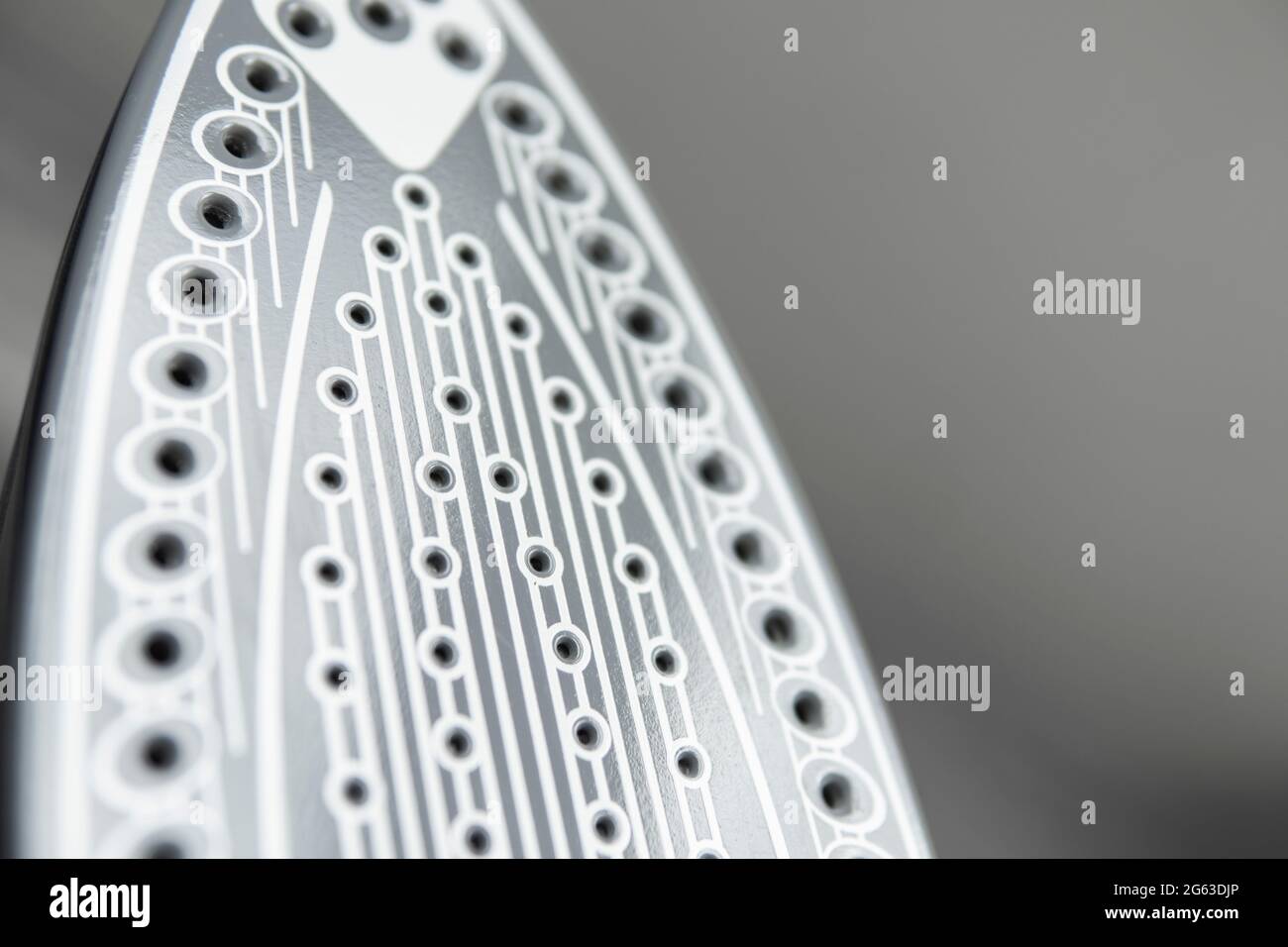 Bottom surface of the Iron with a holes Stock Photo - Alamy
