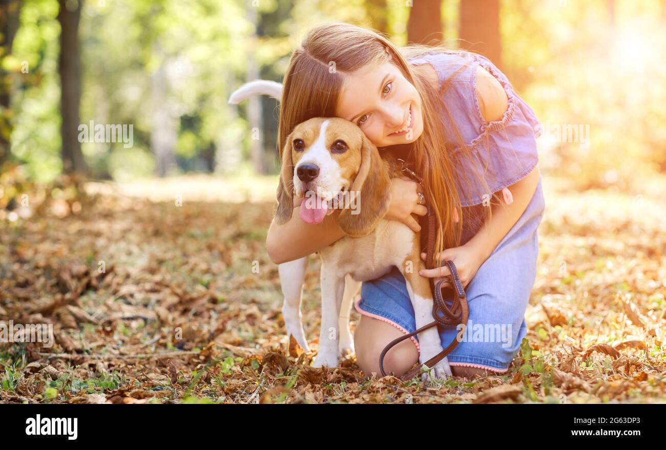 Cheerful kid hugging a dog in summer forest Stock Photo - Alamy