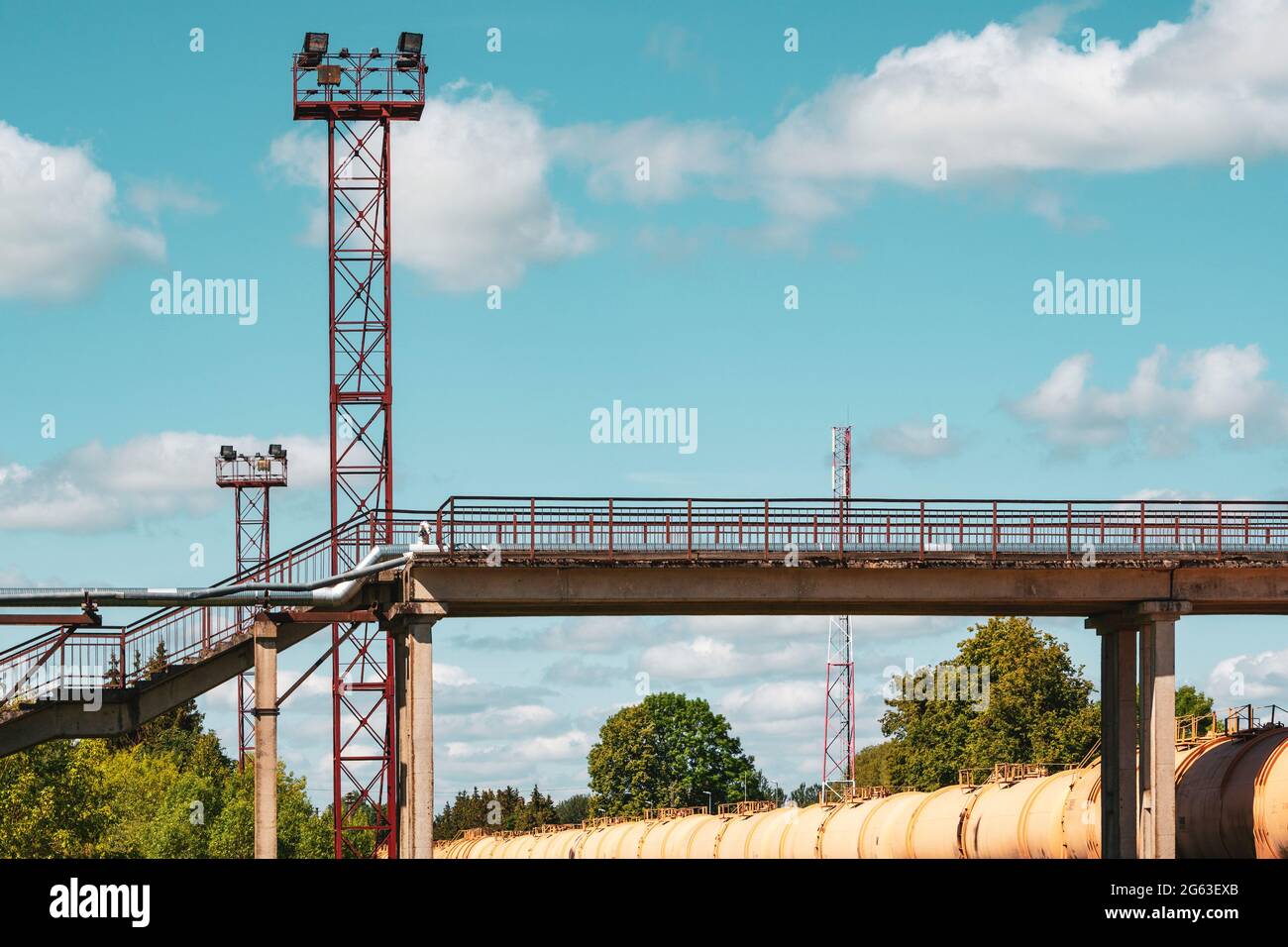 Train with petroleum waggons passing under overbridge for crossing the ...