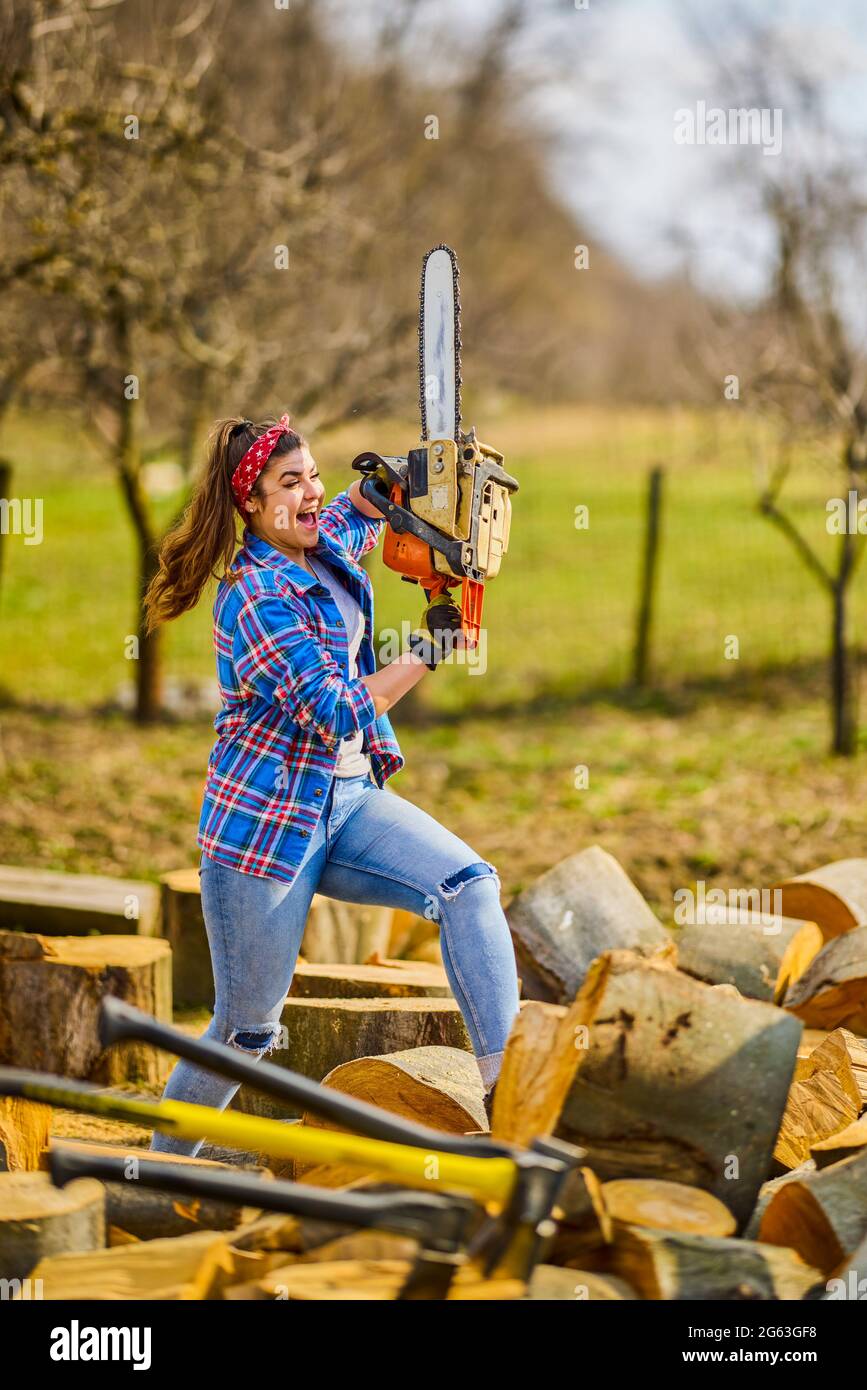 Female cutting firewood hi-res stock photography and images - Alamy
