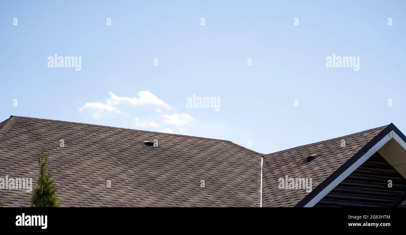 Brown corrugated metal profile roof installed on a modern house. The ...
